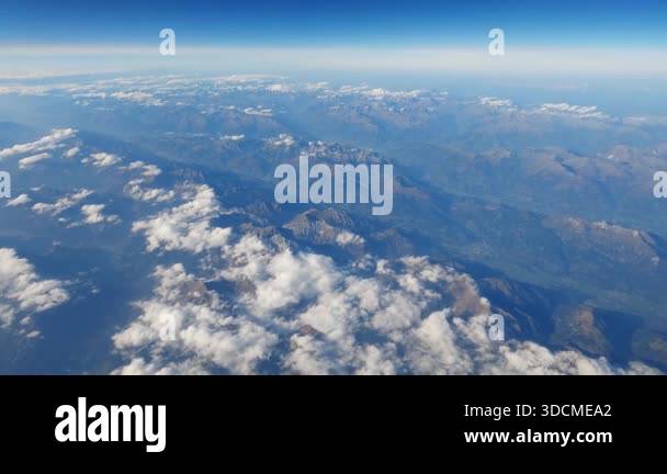 Top view of mountainous terrain from airplane window during flight ...