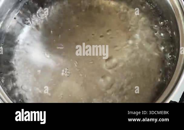 Water in stainless steel pot during the boiling Stock Video Footage - Alamy