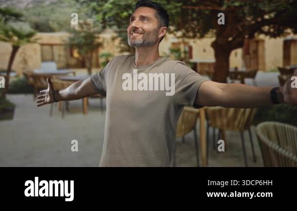 Man standing with arms outstretched and open palms on a restaurant ...