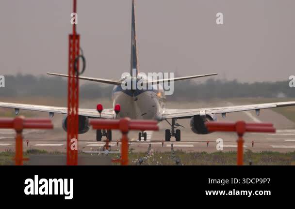 Rear view of a jet airplane on the runway. Aircraft ready takeoff ...