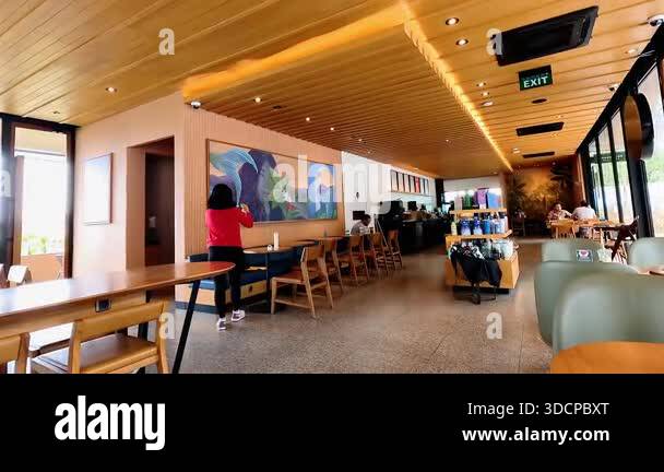 The relaxed atmosphere of Starbucks coffee shop. Customers enjoy ...