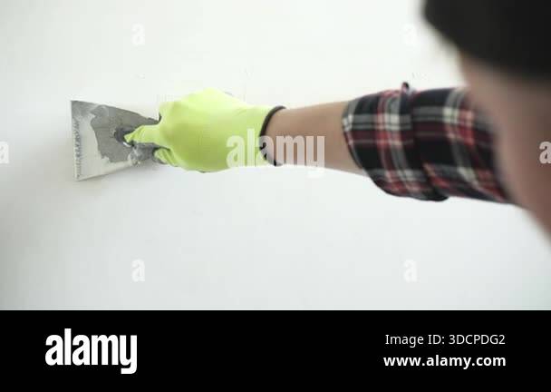 Worker Applies Wall Putty With A Spatula During The Interior Renovation ...