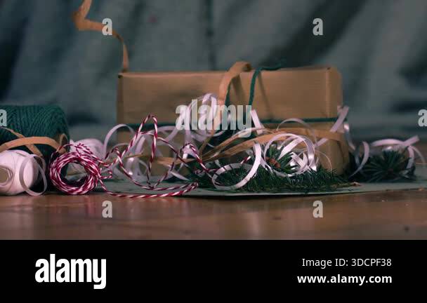 Christmas gift with wrapping ribbon and string green background medium ...