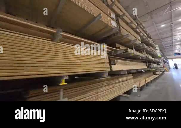 Explore the aisles filled with lumber and tools in a large hardware ...