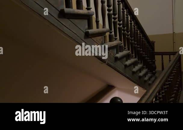 Ancient wooden staircase inside a large city building with creaking ...