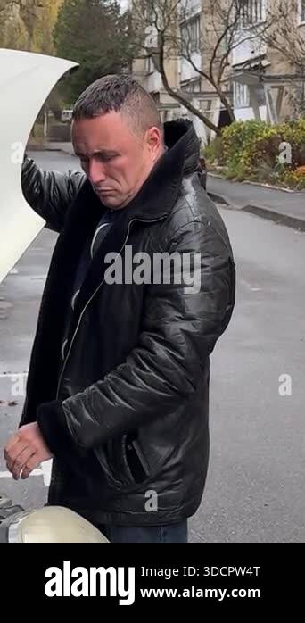 Checking car engine oil, african american man holding dipstick and ...