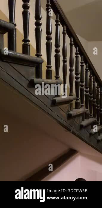 ancient wooden stairs inside a tall city building shows worn creaking ...