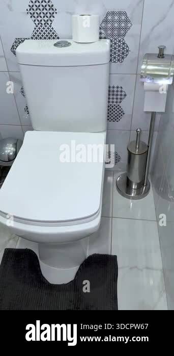 Lifting toilet seat lid in modern bathroom, simple action of opening ...