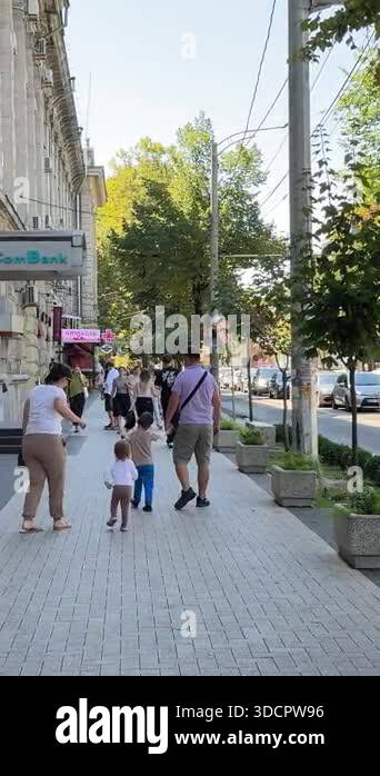 City street scene in Chisinau Moldova with people walking past ...