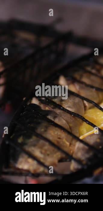 Grilled mackerel fish carcass with a slice of lemon. Grilled fish on a ...