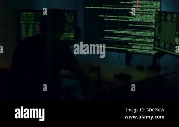 Cyber security analyst engaged with multiple screens filled with code ...