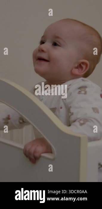 Baby is happily interacting with caregiver in crib, capturing joyful ...