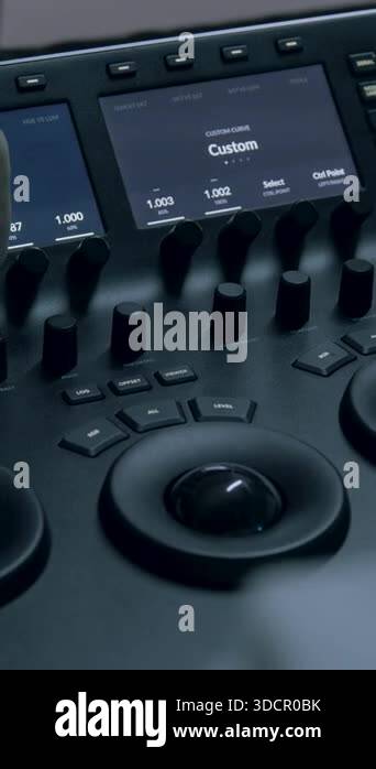 Color grading process in a studio, showcasing a hand adjusting controls ...