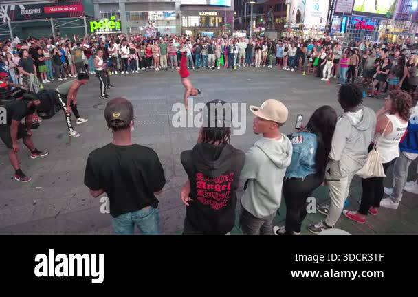 Street break dancer performs powerful acrobatic moves in front of large ...