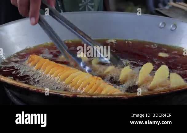 Street Food Vendor Deep Frying Spiral Tornado Potatoes in Hot Oil Pan ...