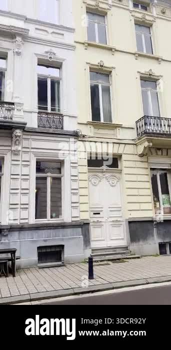 Brussels, Belgium - November 2023: A building shows its yellow outer ...