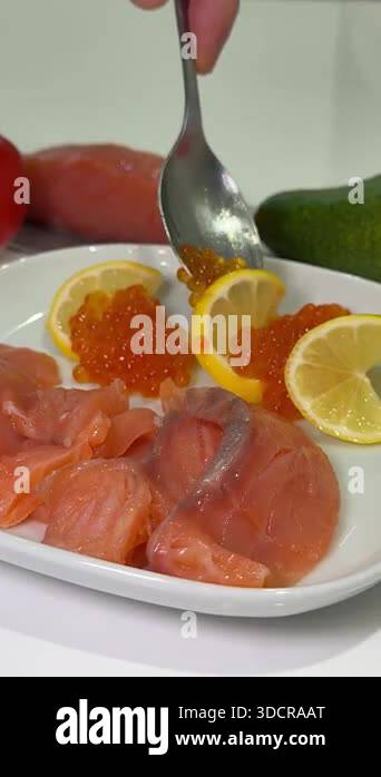 Red salmon fish with caviar and spices rests on an oyster shell ...