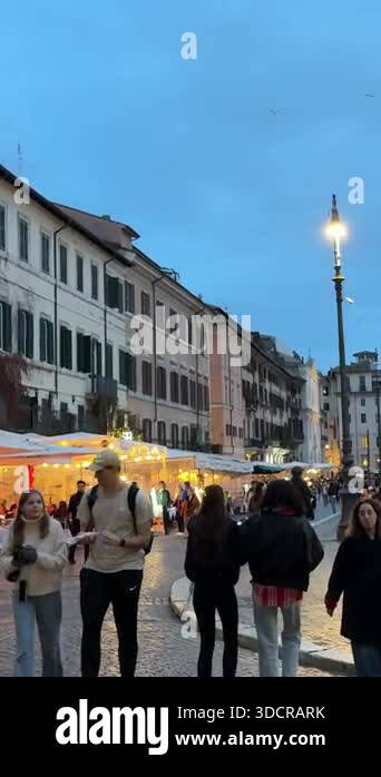 evening scene at Piazza Navona in Rome featuring iconic fountain lively ...