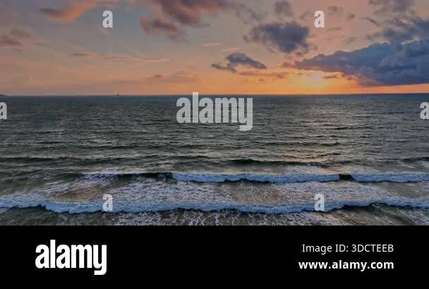 Aerial drone view over ripple sea waves during scenic sunrise with ...