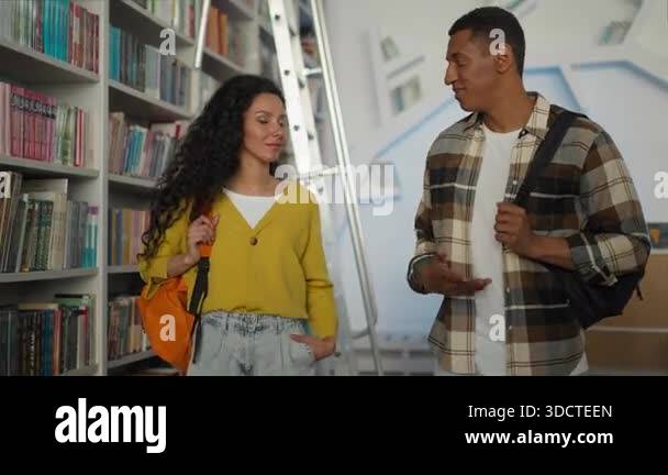 African American man Latina Arabian woman talking going together in ...