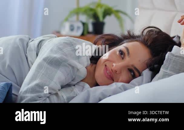 Smiling Caucasian woman waking up awaking in morning smile joyful lying ...