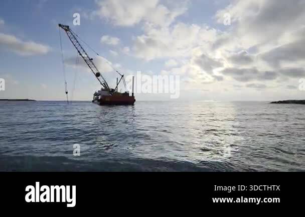 a dredge with crane dredging the sea bottom near the shore Stock Video ...