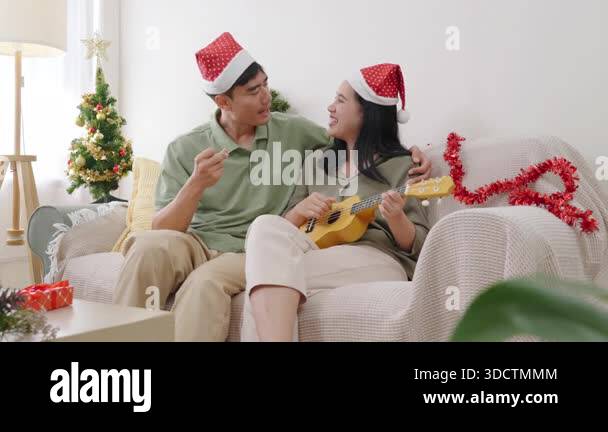 happy christmas family couple enjoying home on couch, xmas tree, gifts ...