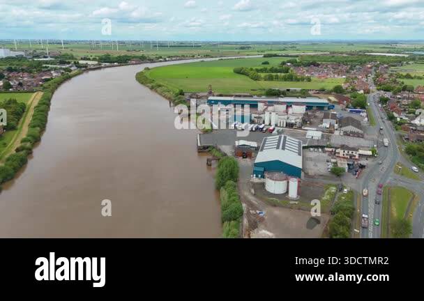 Aerial drone footage of industrial factories near the River Trent, with ...