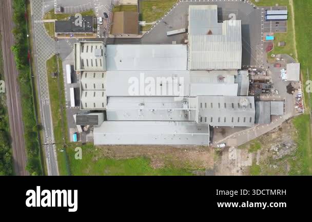 Aerial drone footage of industrial factories near the River Trent, with ...