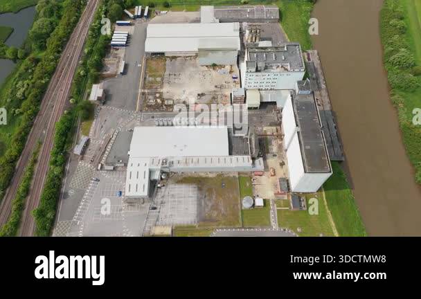 Aerial drone footage of industrial factories near the River Trent, with ...