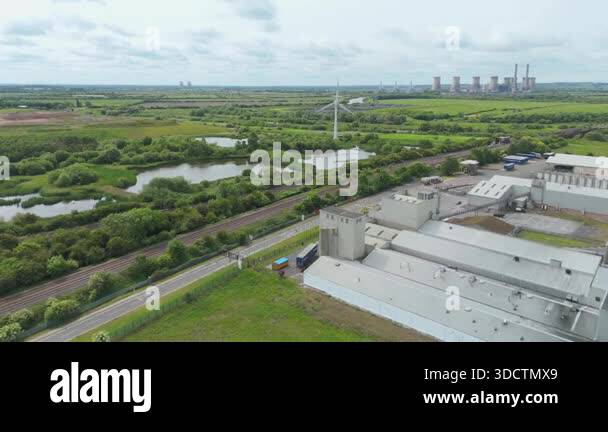 Aerial drone footage of industrial factories near the River Trent, with ...