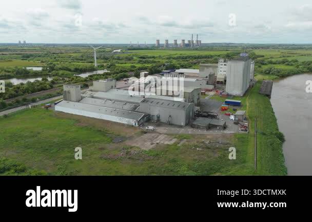 Aerial drone footage of industrial factories near the River Trent, with ...