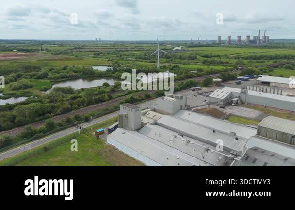 Aerial drone footage of industrial factories near the River Trent, with ...