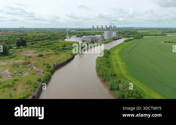 Aerial drone footage of industrial factories near the River Trent, with ...