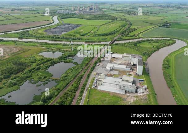 Aerial drone footage of industrial factories near the River Trent, with ...