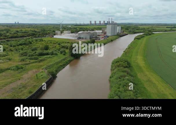 Aerial drone footage of industrial factories near the River Trent, with ...