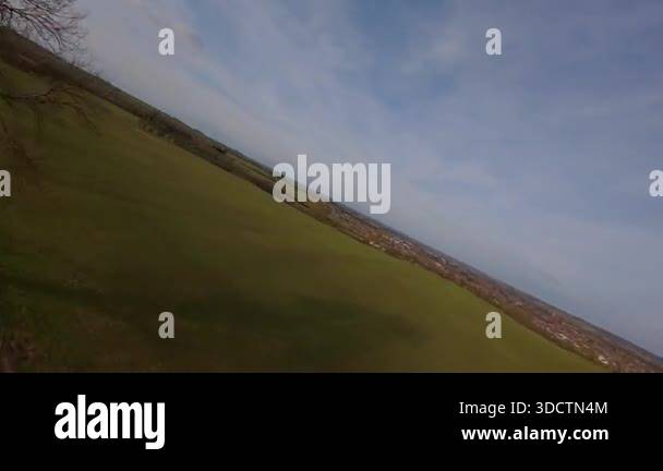 FPV drone aerial view over rural landscape and livestock, sunny England ...