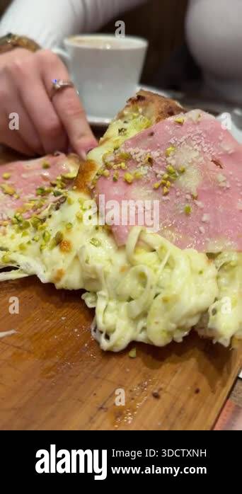 Appetizing Cheesy Italian Pizza with Ham, Cheese and Pistachios, Woman ...