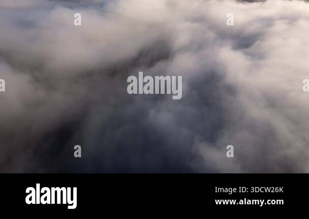 Calm time lapse view from above foggy clouds drifting across a sunny ...