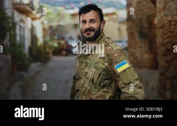 Man with beard in military uniform displaying ukrainian flag patch ...