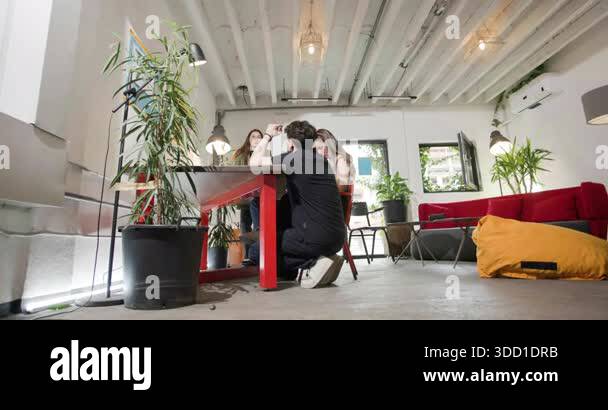 A business team of four collaborates on a project in a modern office ...