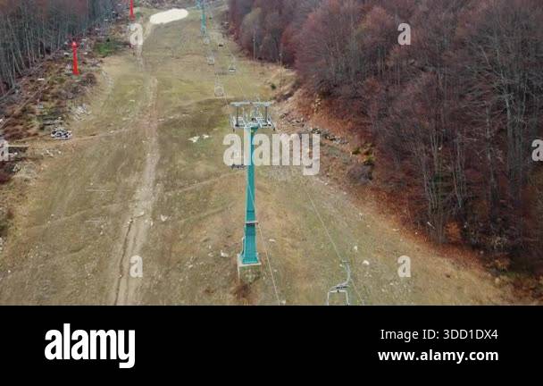 Chairlift on ski slope. Empty ski lift on a grassy mountain in autumn ...