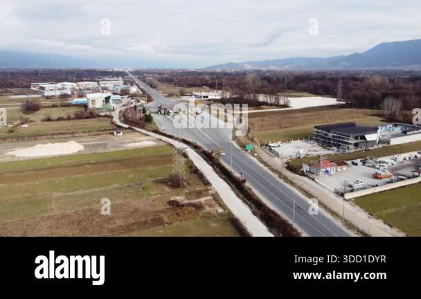 Cars pass through a toll booth on a highway in the countryside ...