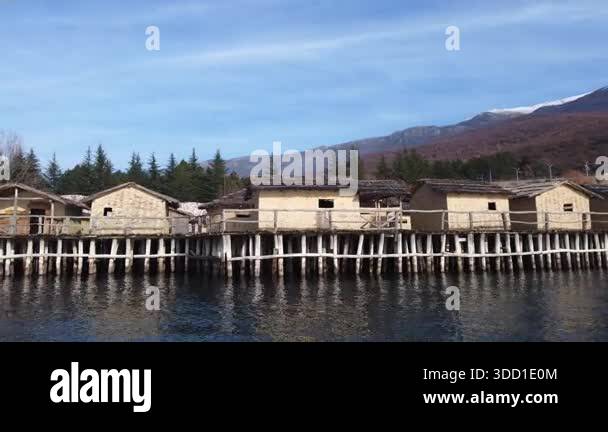 Prehistoric stilt houses by a lake in Ohrid, North Macedonia offer a ...