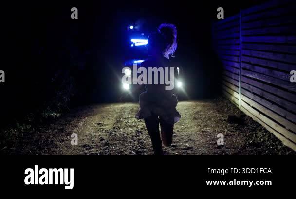 A girl is seen fleeing from police in a secluded location at night. The ...
