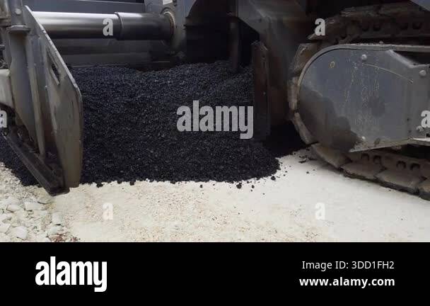 Road construction. Asphalt pavement machine making new layer of asphalt ...