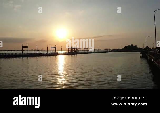 Silhouette of raft bridge with tourist walking and sunset time lapse ...