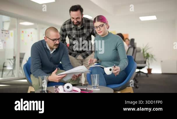 Group of professionals is working together in an office. They share ...