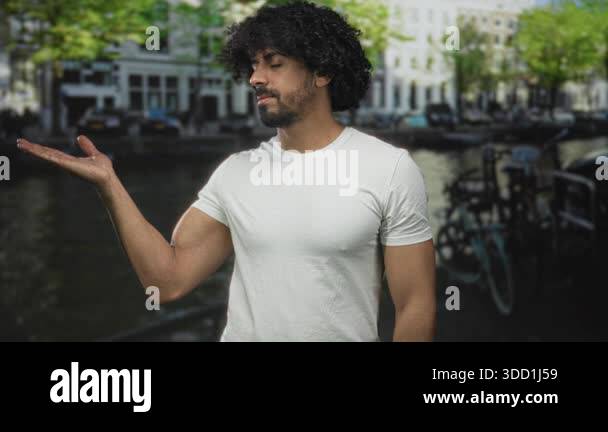 Man with open palm up hand and visible forearm wearing white t shirt on ...