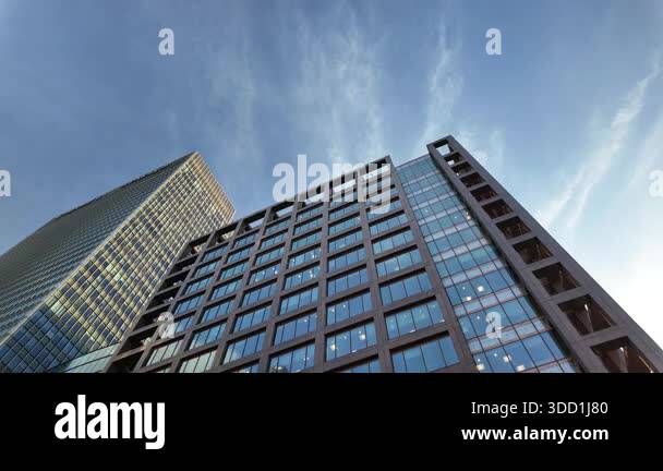 Sky changes above the skyscrapers. From a low angle, clouds rush ...